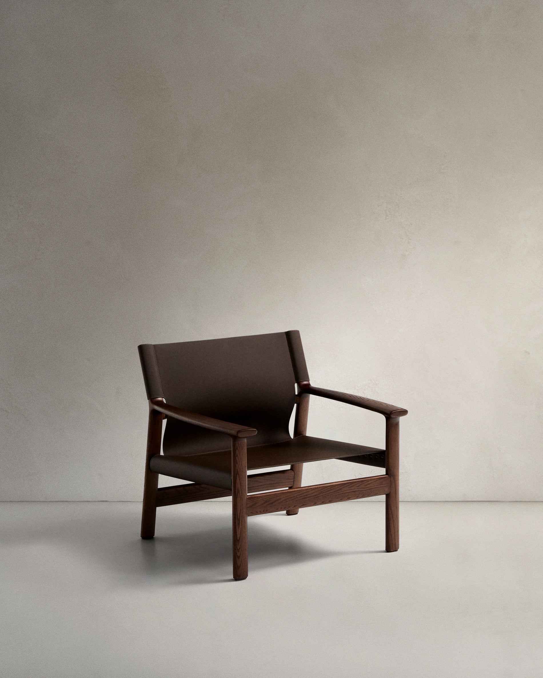 Jan armchair made of dark brown recycled leather fibres and FSC 100% s ...